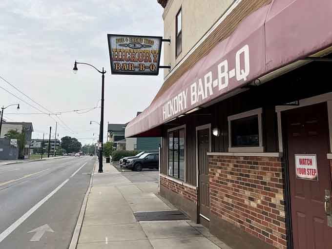 That pink awning has been guiding hungry souls to barbecue paradise for decades, like a delicious lighthouse.