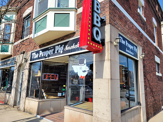The Proper Pig Smokehouse: Where brick, neon, and a cartoon pig promise smoked meat magic that'll make your taste buds do a happy dance.
