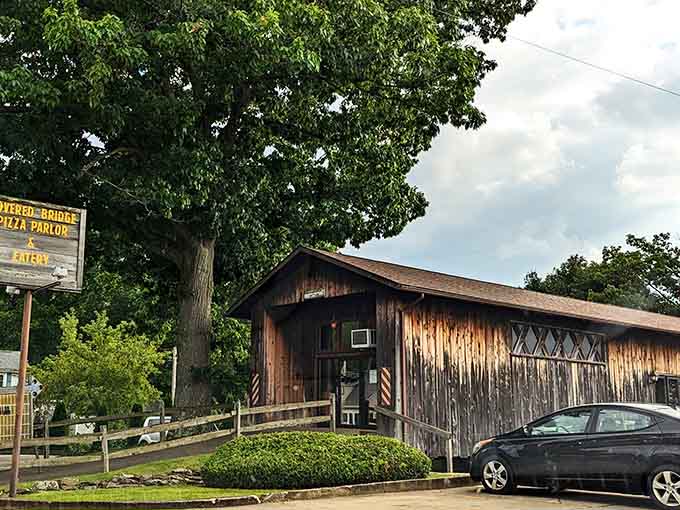 The weathered wooden exterior looks like it's been serving hungry travelers since covered bridges were actually necessary for crossing rivers.