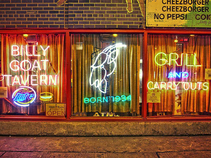 The iconic neon glow of Billy Goat Tavern beckons hungry Chicagoans down to a basement legend where burgers and history are served in equal measure.