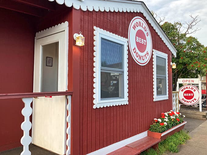 That charming red building with the scalloped trim isn't a dollhouse, it's your new favorite donut destination in Grand Marais.