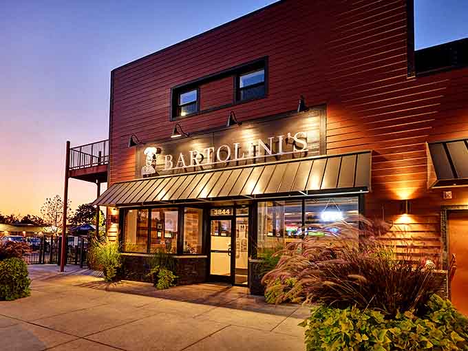 Bartolini's warm wooden exterior glows at twilight, its unassuming facade hiding the culinary adventures waiting inside this Midlothian landmark.