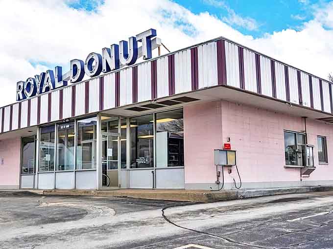 The iconic pink exterior of Royal Donut, where that vintage neon sign has been beckoning sweet-toothed pilgrims since 1973.