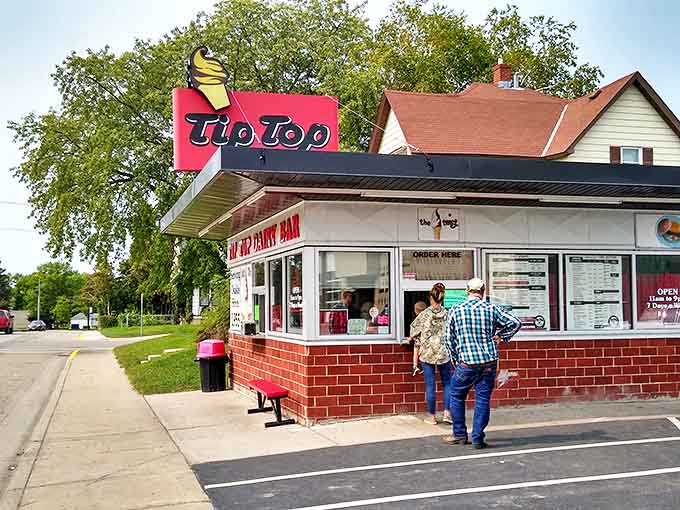 The iconic Tip Top Dairy Bar sign stands proudly against the Minnesota sky, a beacon of burger-and-ice-cream bliss since 1955.