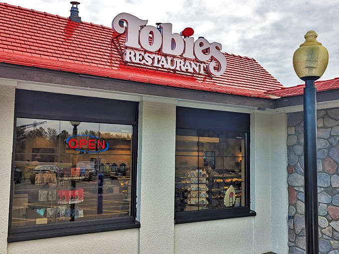 The iconic red roof of Tobie's Restaurant & Bakery stands out like a beacon for hungry travelers, promising sweet salvation just off the highway.