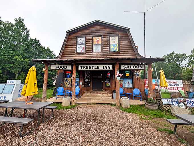 The rustic wooden exterior of Trestle Inn beckons travelers with promises of "FOOD" and "SALOON" &ndash; a woodland oasis waiting to be discovered.