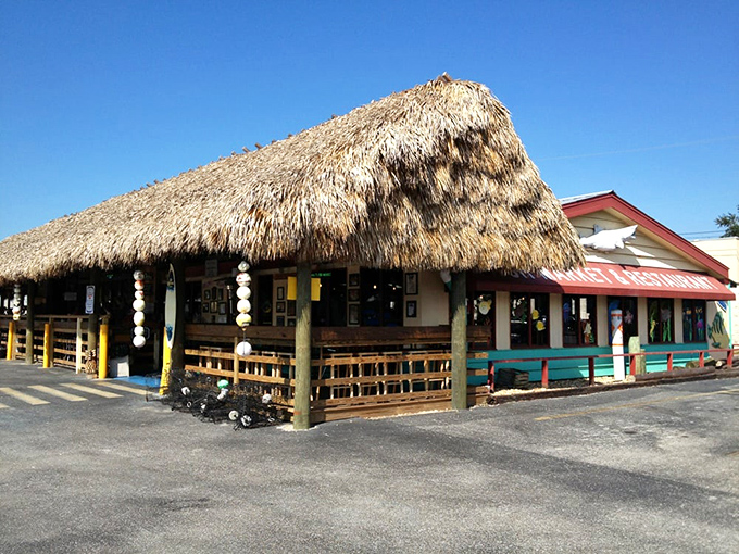Walt's Fish Market Restaurant: The iconic thatched tiki roof welcomes seafood lovers like a tropical beacon, promising fresh catches and Florida charm since 1918.