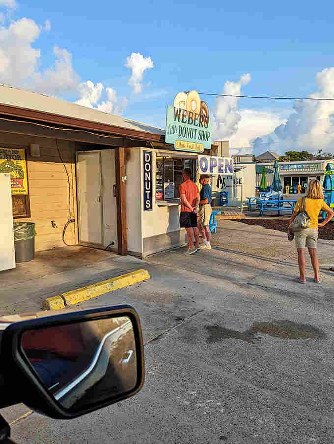 Weber's Little Donut Shop stands like a beacon of fried dough hope, where vacation memories begin with a simple window transaction and end with sticky fingers.
