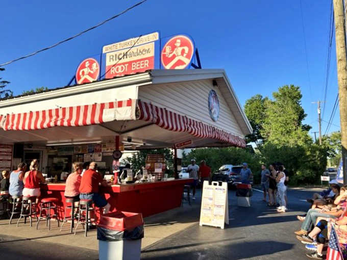 The iconic red and white striped awning of White Turkey Drive-In welcomes visitors like a candy-cane beacon of deliciousness from another era.