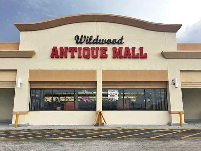 The unassuming exterior of Wildwood Antique Mall belies the treasure trove within – like finding a portal to the past disguised as a strip mall storefront.