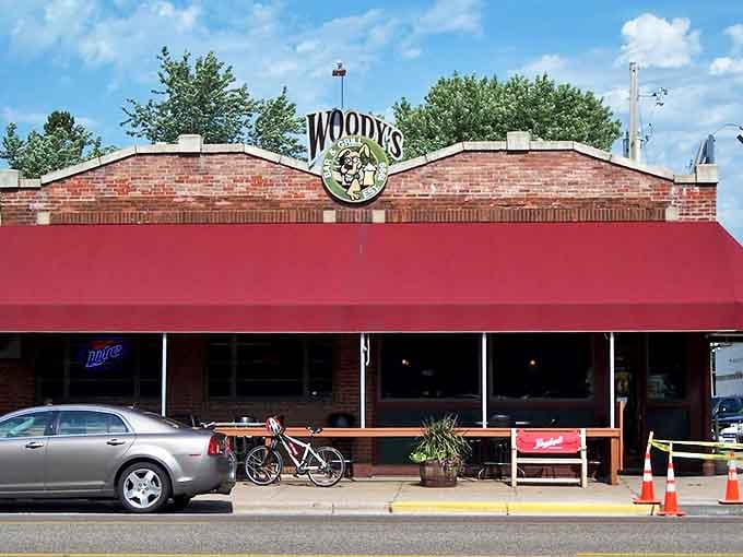 Woody's brick exterior with its classic red awning stands like a beacon of comfort food and hidden fun in downtown Bayport.