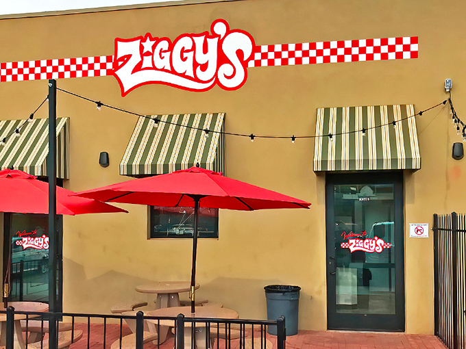 Ziggy's welcoming exterior beckons with its sunny yellow walls and iconic red-checkered logo &ndash; the unassuming gateway to pinball paradise.