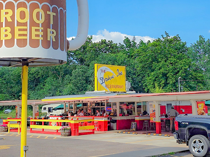 That towering root beer mug sign is basically a superhero beacon for hungry people, except instead of fighting crime, you'll be fighting the urge to order everything on the menu.