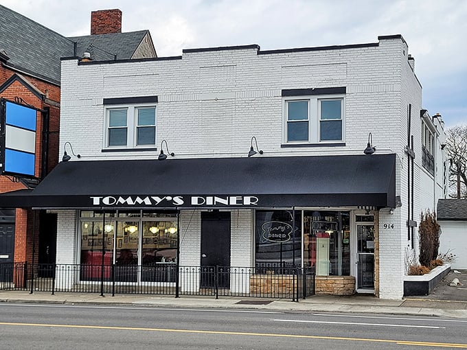 Tommy's Diner's classic white brick exterior with its bold black awning stands as a beacon of nostalgia on West Broad Street in Columbus.