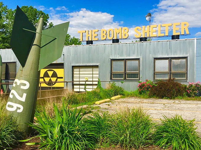 The Bomb Shelter's exterior greets visitors with Cold War chic – a missile fin stands guard while bold yellow letters promise vintage adventures within.