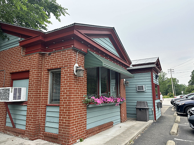 The charming brick-and-blue exterior of Gasoline Alley beckons with its retro charm and colorful flower boxes &ndash; an unassuming preview of the wonders within.