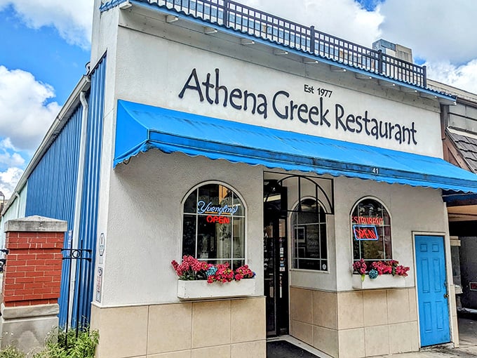 The iconic blue awning of Athena Greek Restaurant stands as a beacon of Mediterranean flavor in downtown Mansfield since 1977.