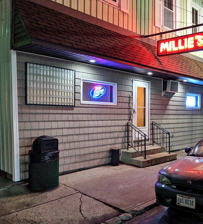 The unassuming exterior of Millie's Cafe hides a wing lover's paradise behind that simple door and neon beer sign.