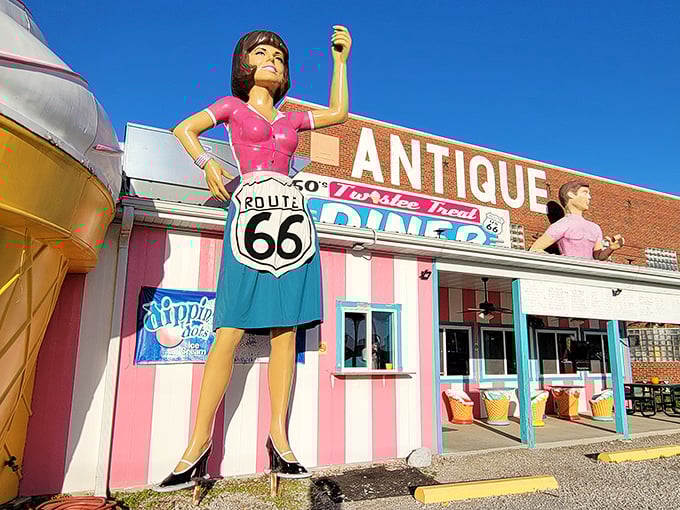 A retro wonderland awaits! The Pink Elephant Antique Mall's candy-striped exterior and fiberglass greeters transport visitors straight back to Route 66's heyday.