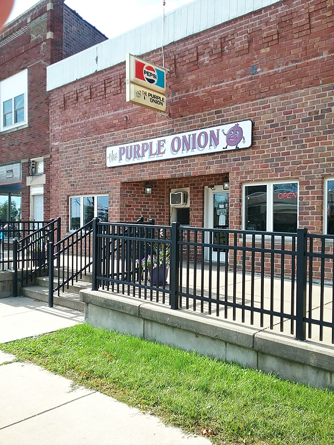 The brick fa&ccedil;ade of The Purple Onion welcomes hungry travelers with its charming purple sign &ndash; a beacon of comfort food in Annawan's landscape.