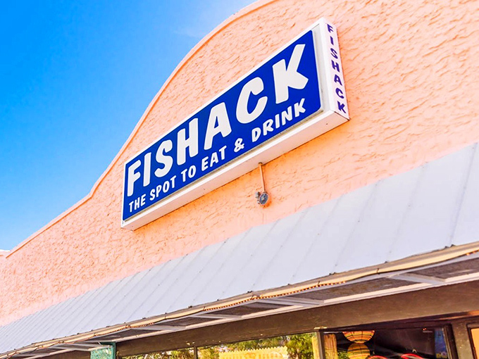 The peachy facade of Fishack stands proud against Florida's blue sky, promising seafood treasures within its humble walls.