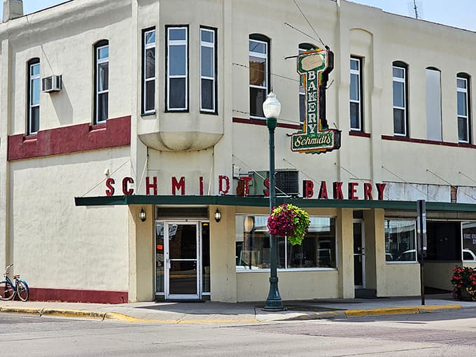 The iconic cream-and-red fa&ccedil;ade of Schmidt's Bakery stands proudly on the corner, its vintage sign beckoning carb enthusiasts like a sugary lighthouse.