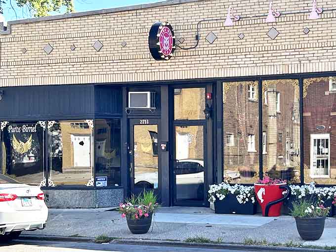 The Pink Owl Cafe's inviting exterior beckons with its signature logo and flower boxes, promising a rosy escape from the ordinary.