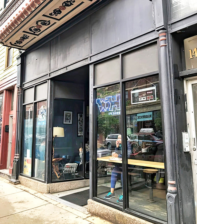 The Wormhole Coffee's sleek black exterior with its distinctive signage stands as a portal to nostalgic adventures within Chicago's vibrant Wicker Park neighborhood.