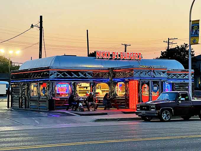 Exterior: Gleaming like a chrome time machine under the twilight sky, Nicky D's neon sign beckons hungry travelers into a slice of 1950s Americana.