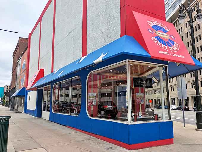 The iconic red, white, and blue exterior of American Coney Island stands as a patriotic beacon in downtown Detroit, welcoming hungry visitors since 1917.