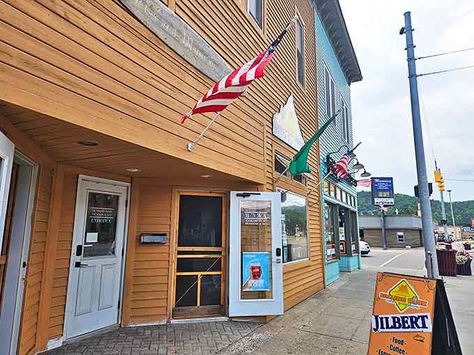 Exterior: Unassuming wooden facade with American flag – the literary equivalent of "don't judge a book by its cover." Pure Michigan charm awaits inside.