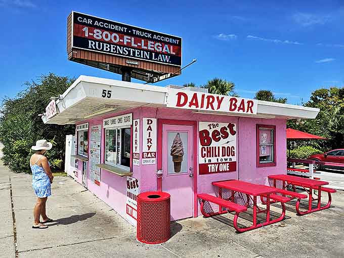 A candy-pink time capsule beckons from the roadside, promising "The Best Chili Dog in Town" beneath a Florida sky that seems to stretch forever.
