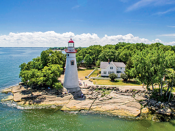 Marblehead Lighthouse stands sentinel on the rocky shore, guiding visitors to Kelleys Island with its iconic red-topped beacon.