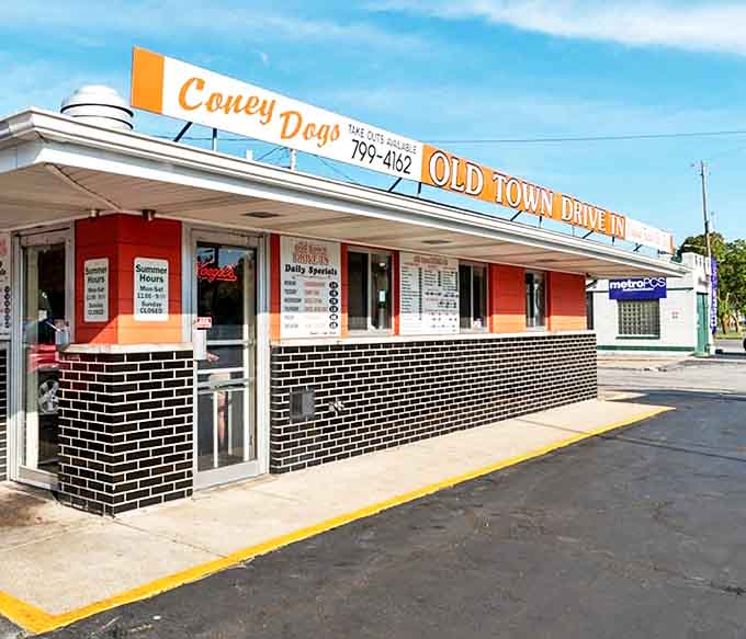 The iconic orange and black exterior of Old Town Drive-In stands as a beacon of nostalgia along Saginaw's streets, promising comfort food perfection.
