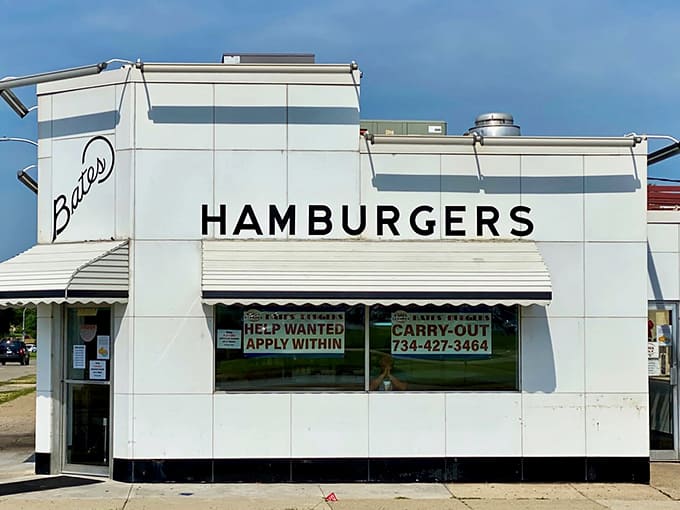 The iconic white porcelain exterior of Bates Burgers stands like a time capsule from the 1950s, promising authentic flavors inside.