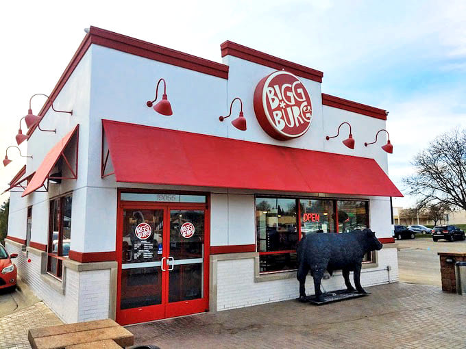 Exterior: A cheerful red-and-white building with a life-sized cow statue standing guard &ndash; Bigg Burger's unassuming exterior hides culinary treasures within.