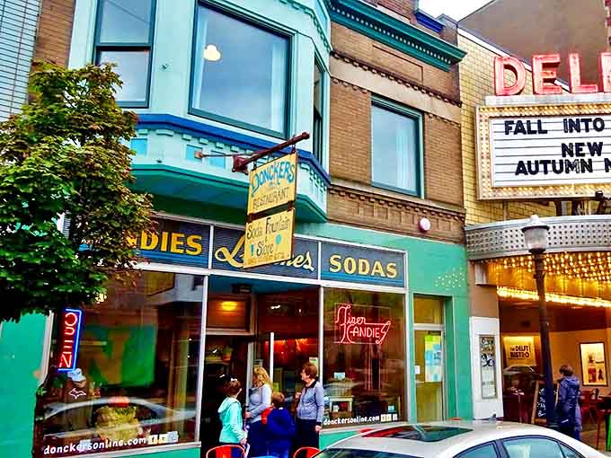 The iconic turquoise storefront of Doncker's beckons with vintage charm, its neon "CANDIES" sign promising sweet adventures within Marquette's historic downtown.