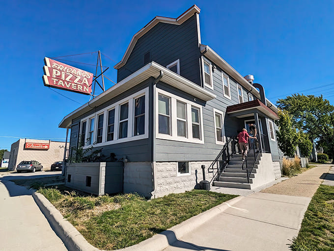 Fricano's Pizza Tavern stands proudly in Grand Haven, its vintage sign a beacon for pizza pilgrims seeking thin-crust perfection.