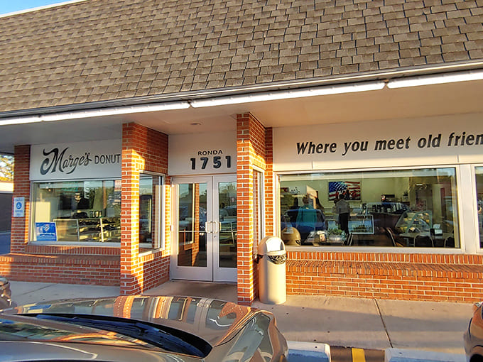 Exterior: The unassuming brick fa&ccedil;ade of Marge's Donut Den promises sweet treasures within. That vintage sign isn't lying&mdash;this is where memories are made.