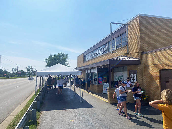 The iconic yellow brick exterior of Sherman's Dairy Bar, where summer dreams and blue cows have welcomed ice cream pilgrims for generations.