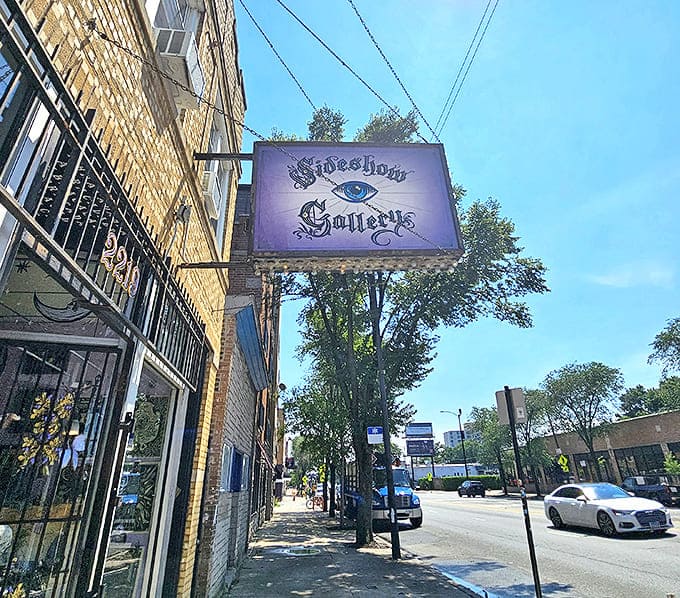 The mystical purple sign of Sideshow Gallery beckons from a brick building, promising curious treasures for those brave enough to enter.