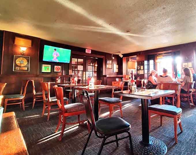 The second-floor dining area offers a quieter retreat with sporting photographs that tell stories of matches long past.