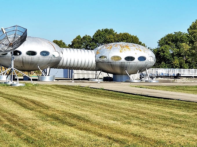 The satellite dish stands ready to communicate with distant stars, completing the cosmic fantasy of this roadside wonder.