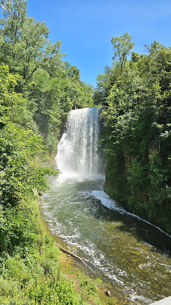 Another perspective of the falls reveals how the water has sculpted its path through ancient limestone, a geological story millions of years in the making.