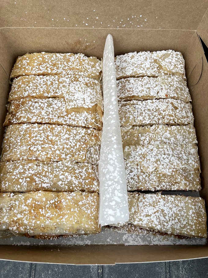 Powdered sugar dusted perfection – each slice representing generations of Hungarian baking tradition in delicious, portable form.