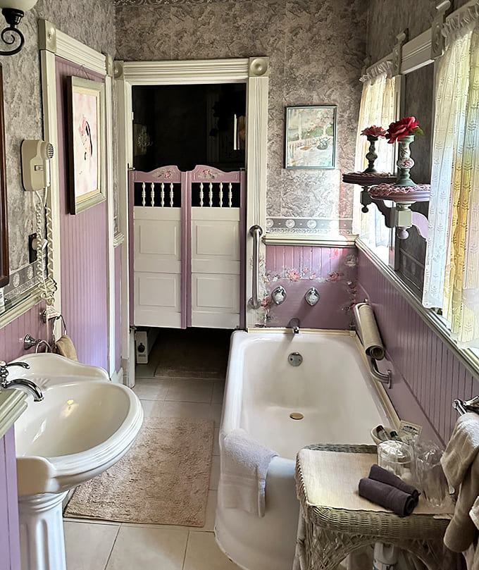 The vintage bathroom with its clawfoot tub and saloon-style doors makes modern spa experiences seem positively pedestrian by comparison.
