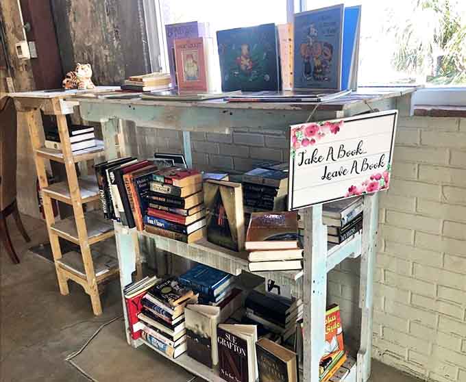 "Take A Book, Leave A Book" invites literary wanderers to discover new worlds between sips, with well-loved volumes awaiting their next reader.