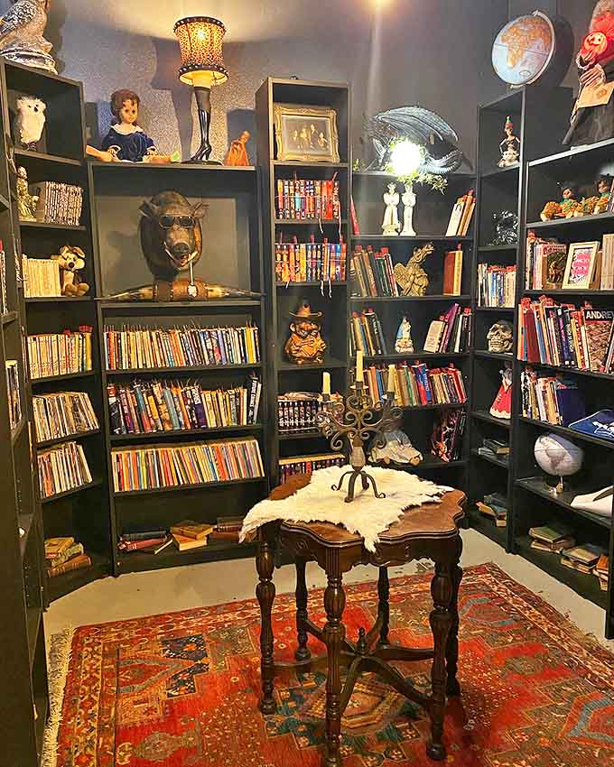 A reading nook that looks like it belongs in a gothic novel, complete with animal heads keeping watch over your literary adventures.
