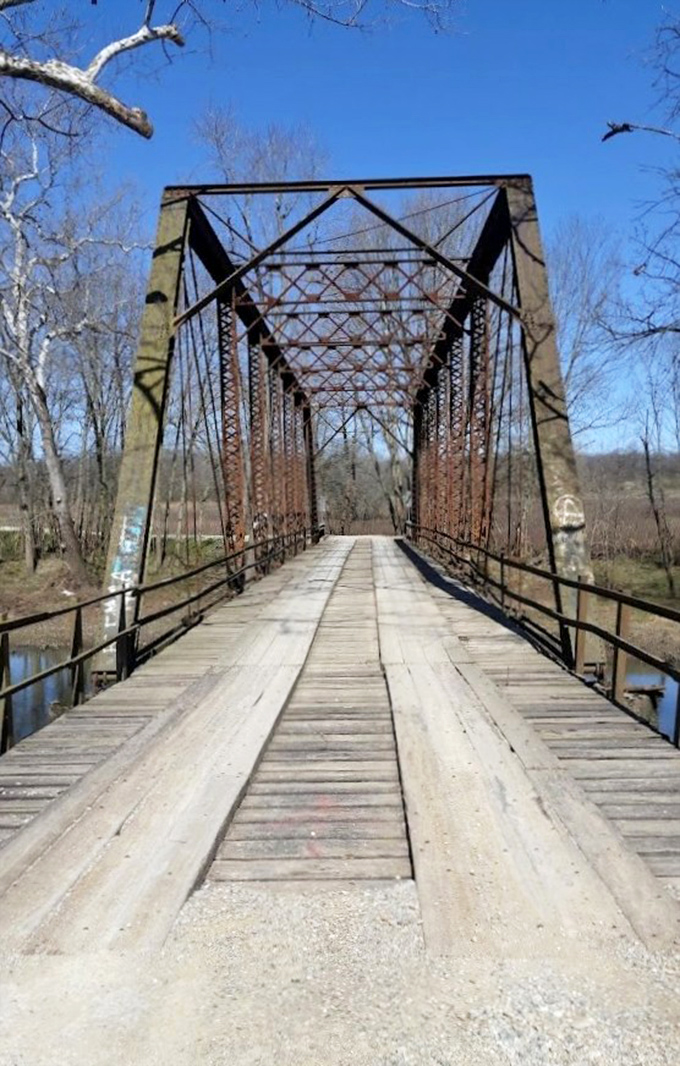 The bridge's distinctive truss design creates a tunnel-like passage that seems to lead into another dimension entirely.