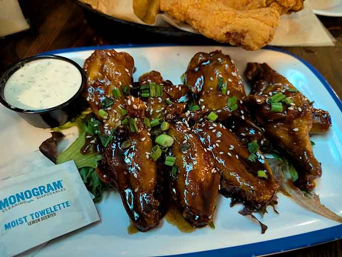 Wings glazed to perfection and garnished with sesame seeds, proving this pub knows its way around more than just traditional British fare.